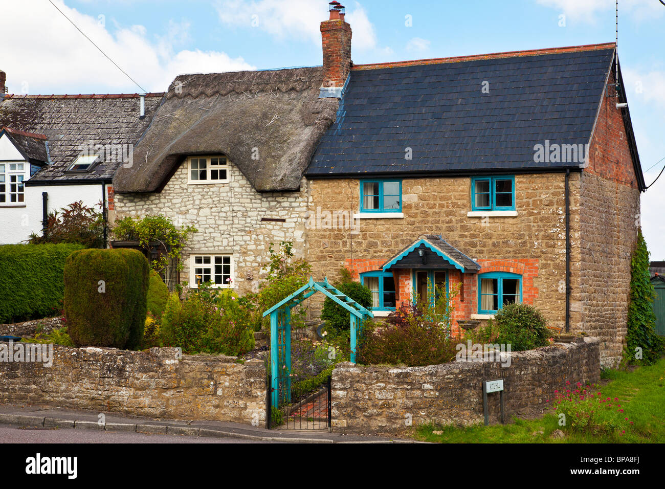 Two typical English stone cottages, one with tiled roof and one ...