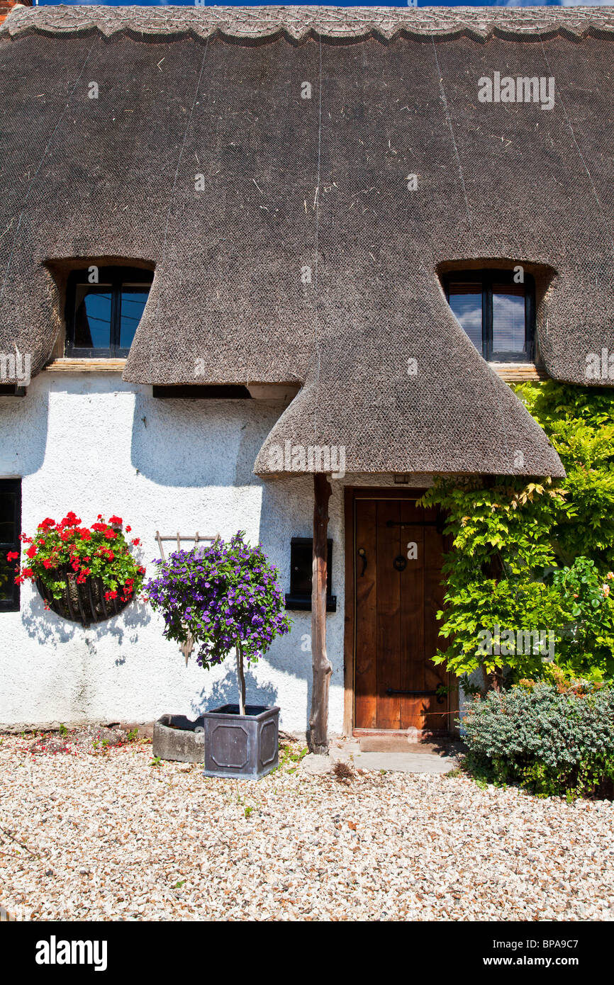 Typical pretty English thatched cottage in the Wiltshire village of ...