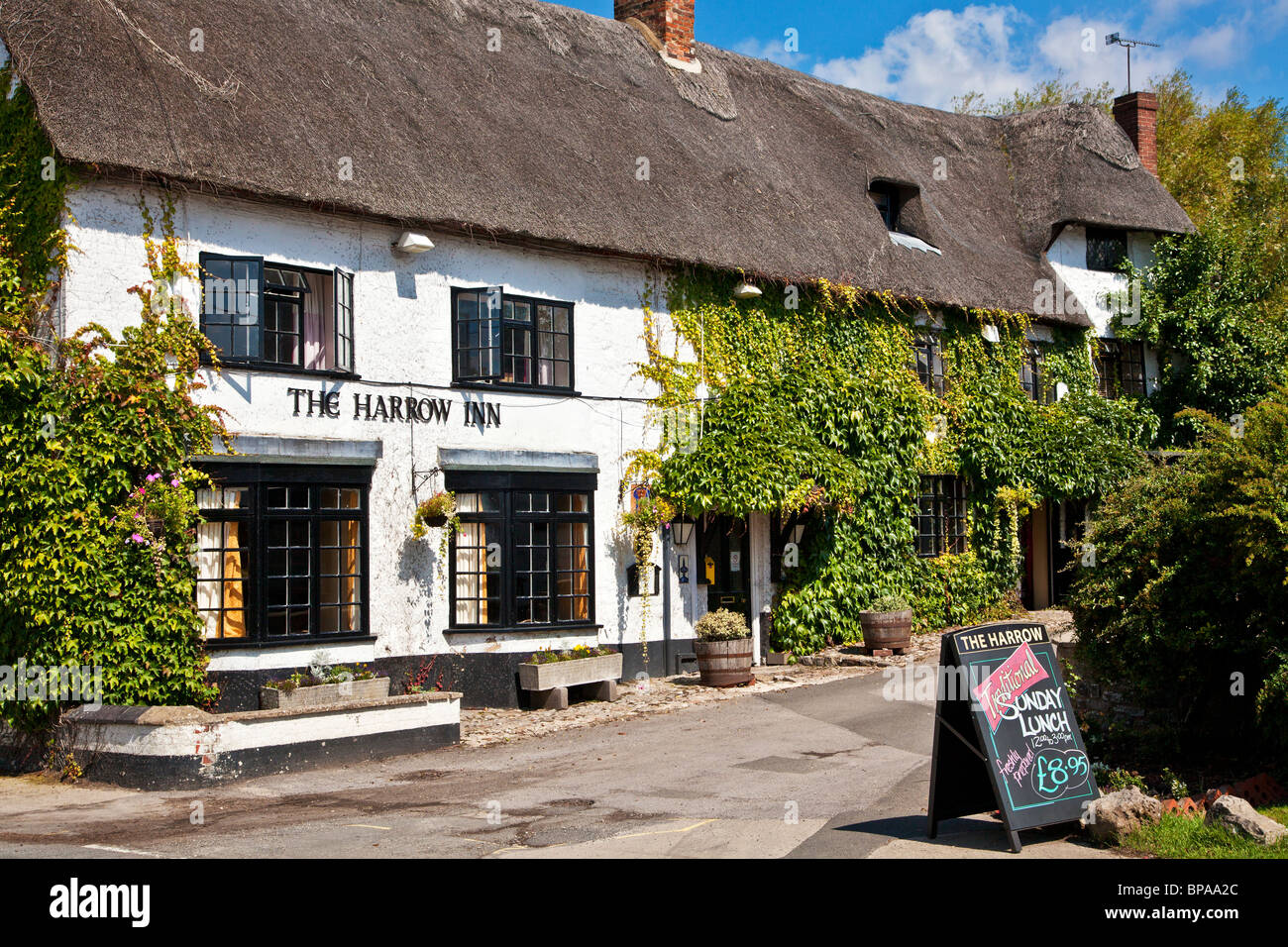 Typical pretty English thatched pub or inn in the Wiltshire village of ...