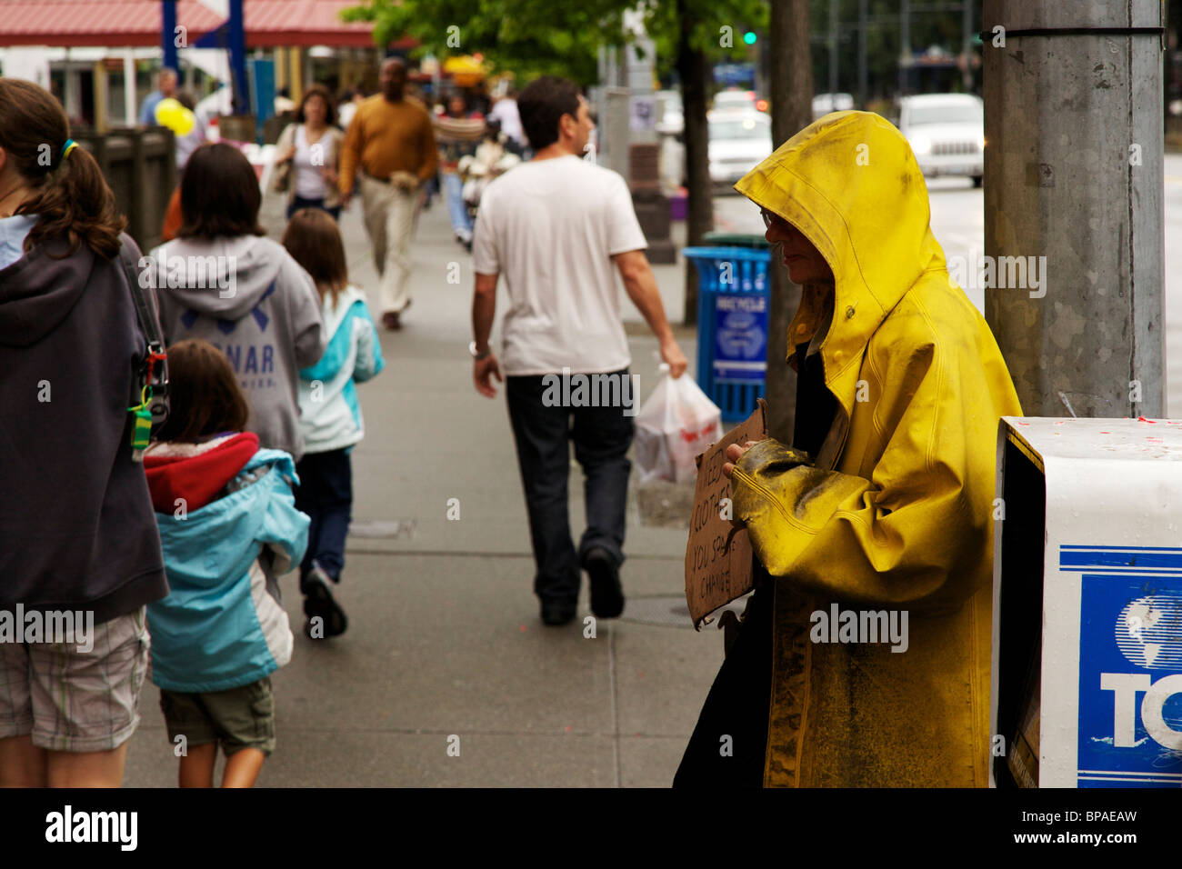 Homeless woman in yellow raincoat Seattle Washington Stock Photo - Alamy