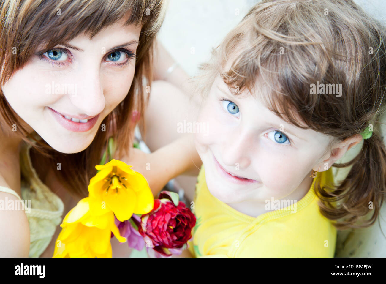 Portrait of mother and child picking flowers Stock Photo - Alamy