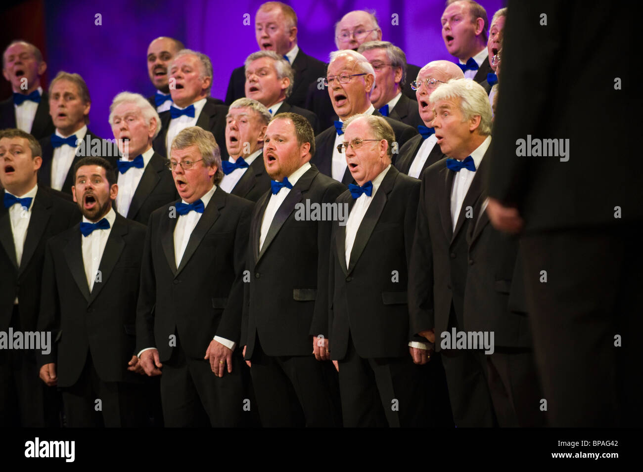 Male voice choir singing on stage in competition at the National ...