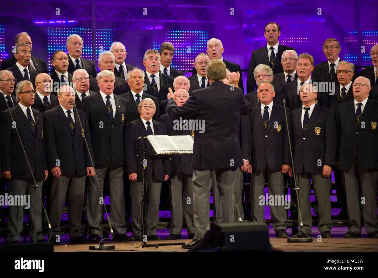 Male voice choir singing on stage in competition at the National ...