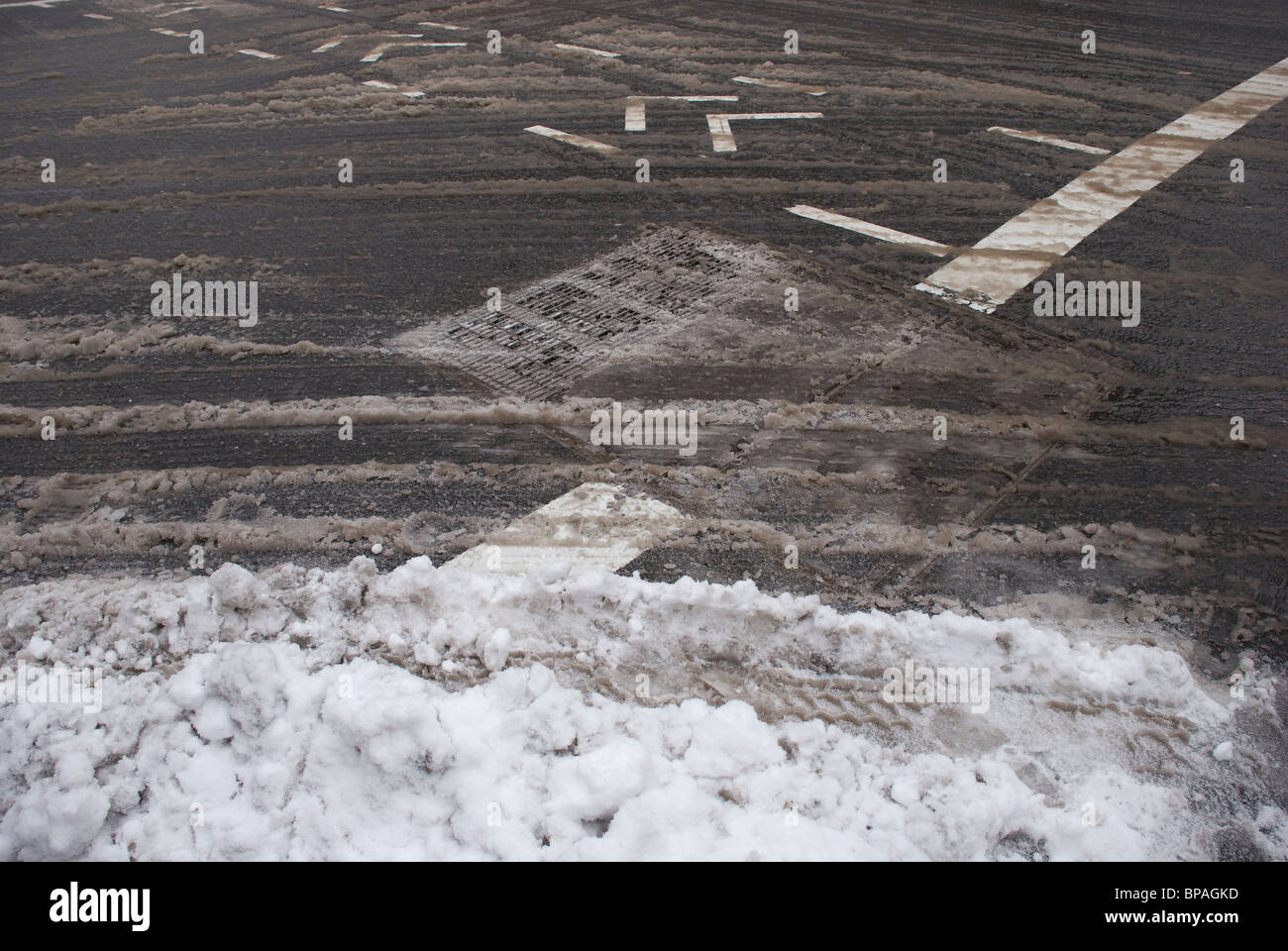 Wet snow and slush at intersection crosswalk Stock Photo - Alamy