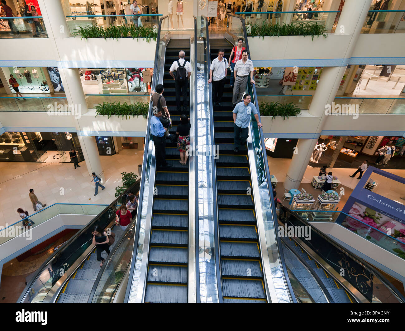 escalators at Peninsula Shopping Centre Singapore Stock Photo - Alamy
