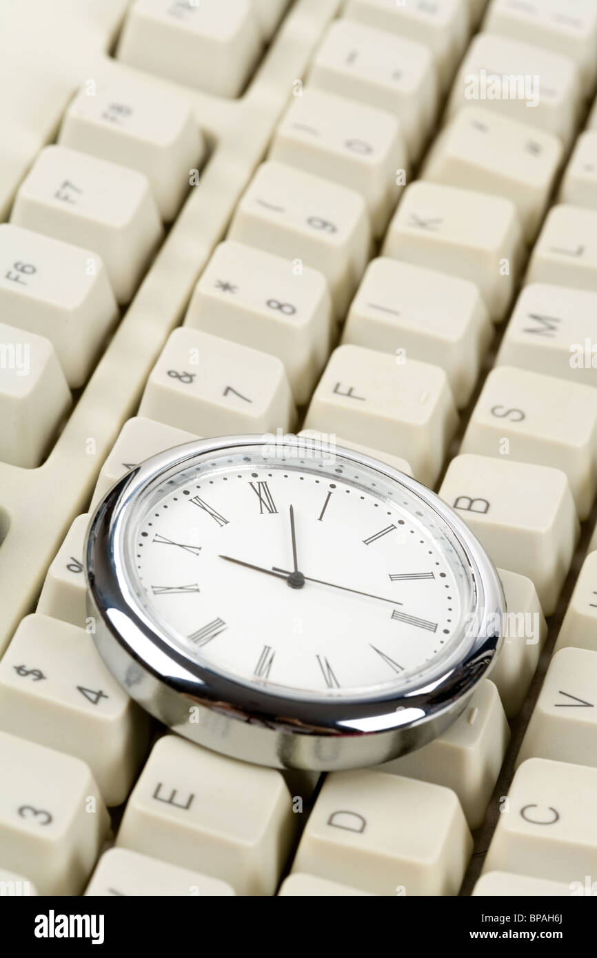 Clock and computer Keyboard close up Stock Photo - Alamy