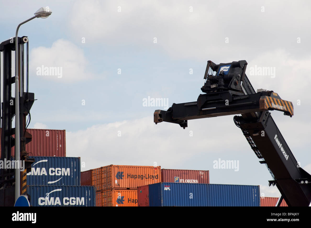 A Lift Truck arm ready to pick up a shipping container in a shipping ...