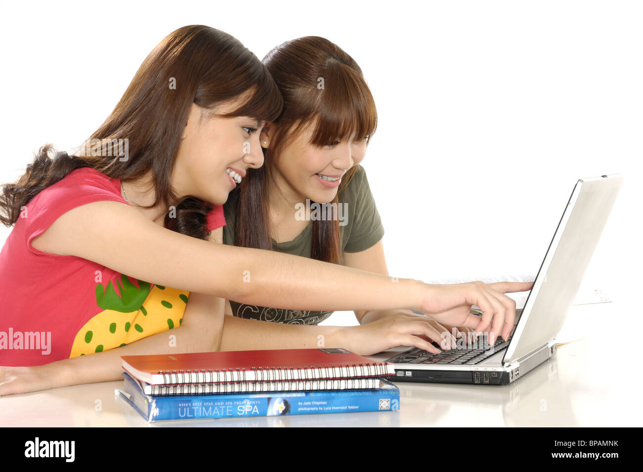 Two female university students using a laptop Stock Photo - Alamy