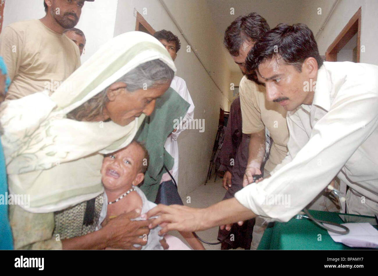 Doctor examines flood affected child at flood affectees relief camp ...
