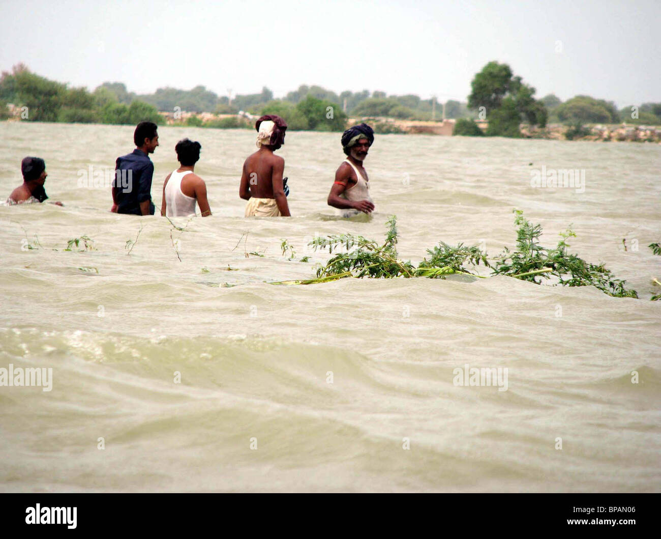 Flood affected people move towards safe place through flooded area ...