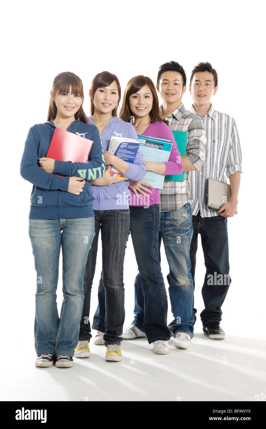 Portrait of university students holding books and smiling Stock Photo ...