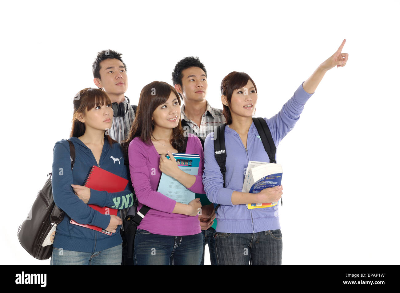 University student pointing with her friends standing beside him Stock ...
