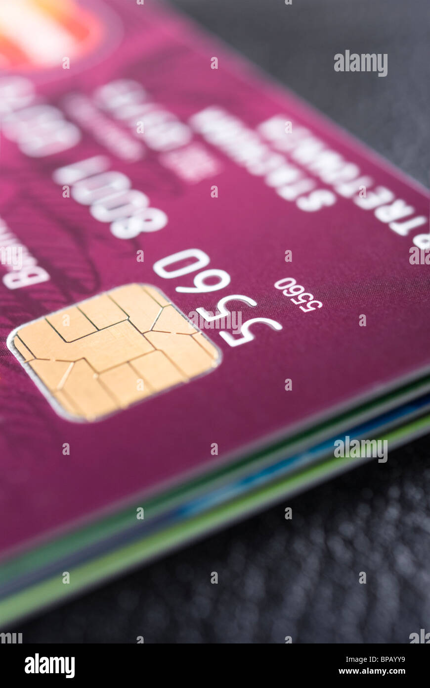 Stack of credit cards with details of a card with its chip and some ...