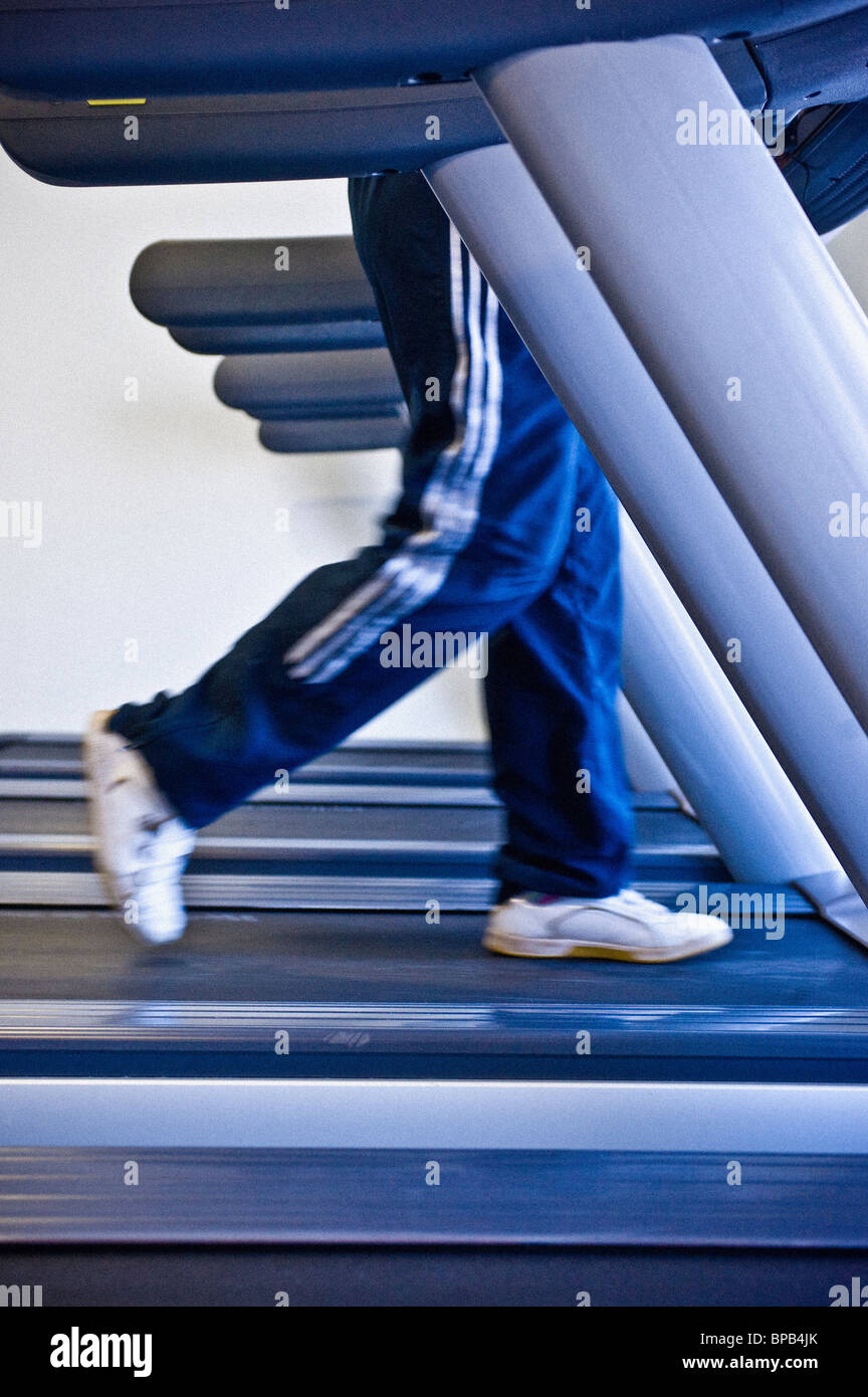 Unidentifiable legs wearing loose jogging bottoms running on a ...