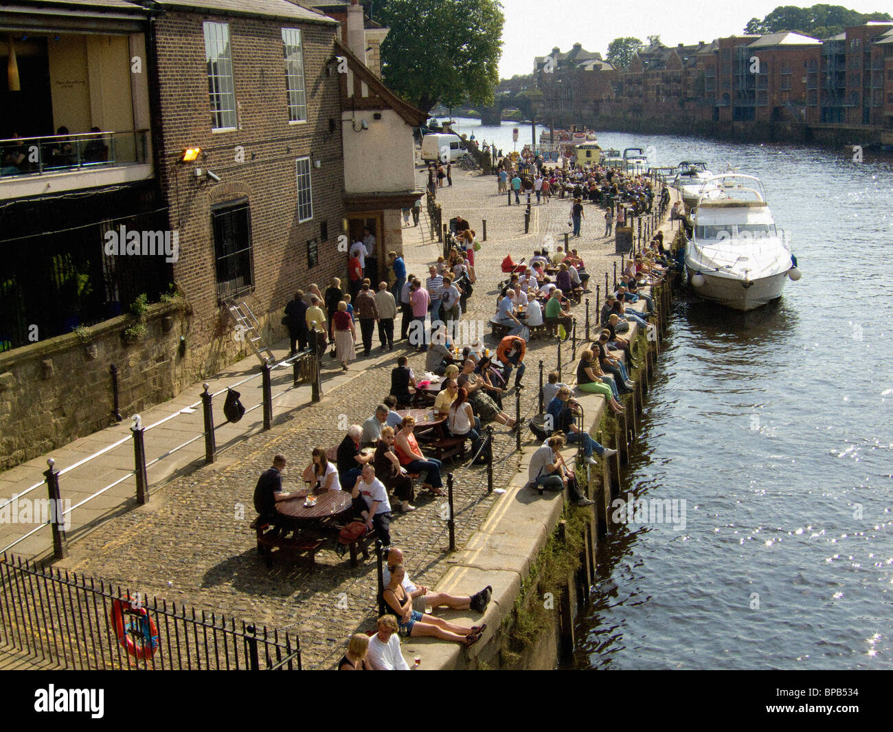 The riverbank at Kings Staith packed with people enjoying the summer ...