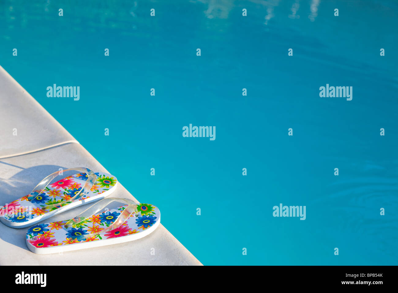 flip-flop near swimming-pool in morning sun Stock Photo - Alamy