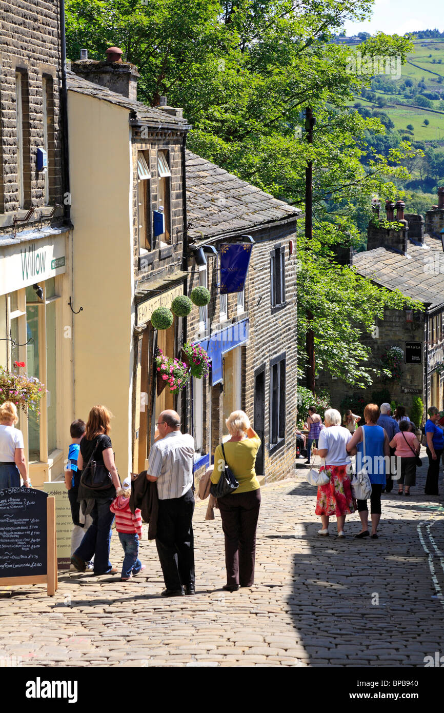Visitors on cobbled Main Street in Haworth, West Yorkshire, England, UK ...