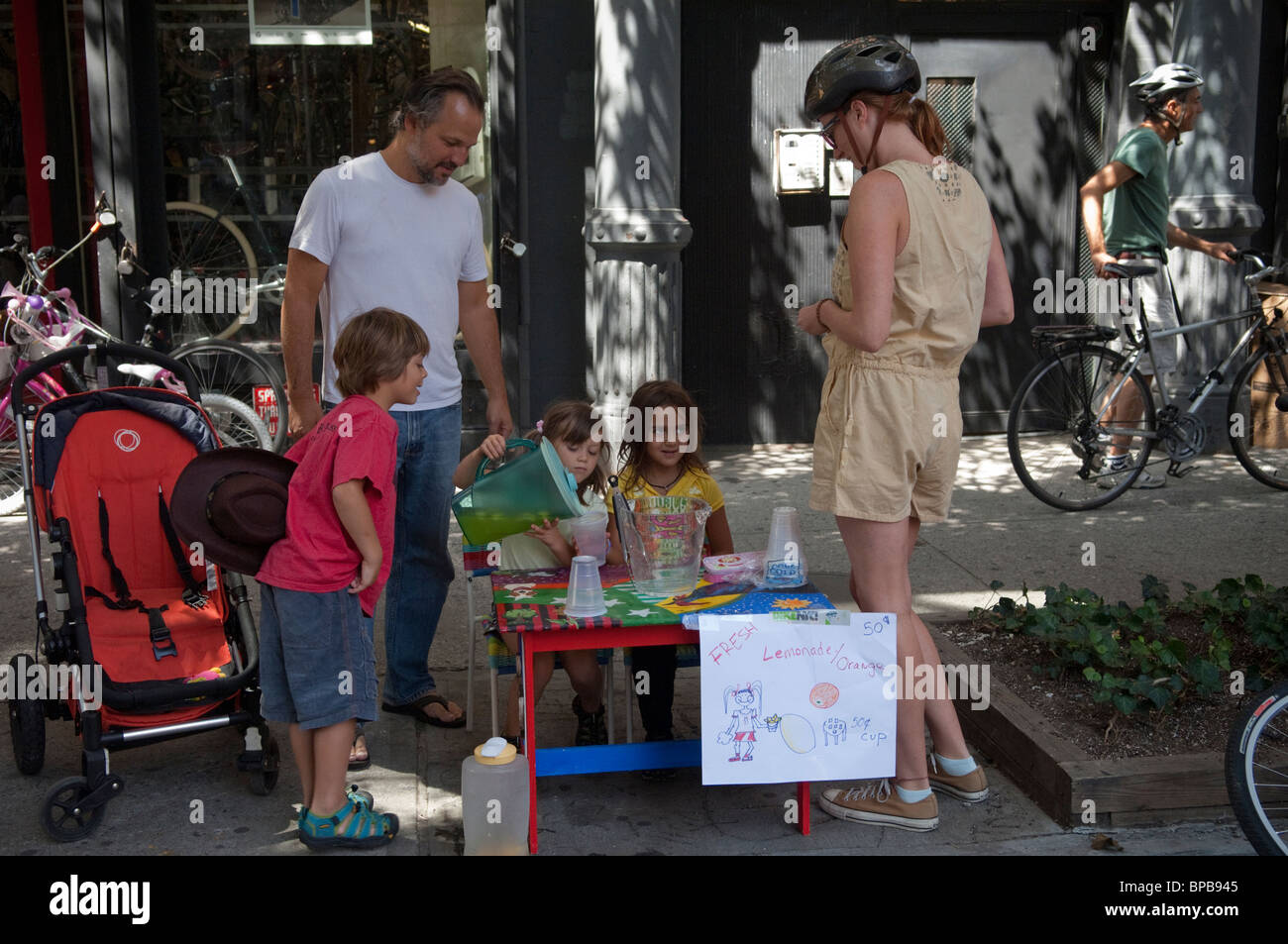 Kids run a lemonade stand during the Summer Streets event in the East ...
