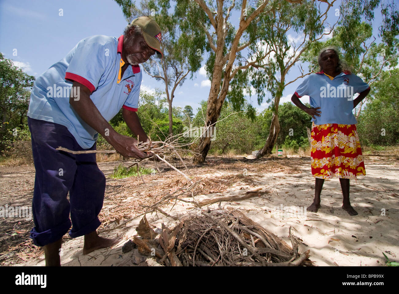 An aboriginal man from the MV Pikkuw prepares a fire for cooking while ...