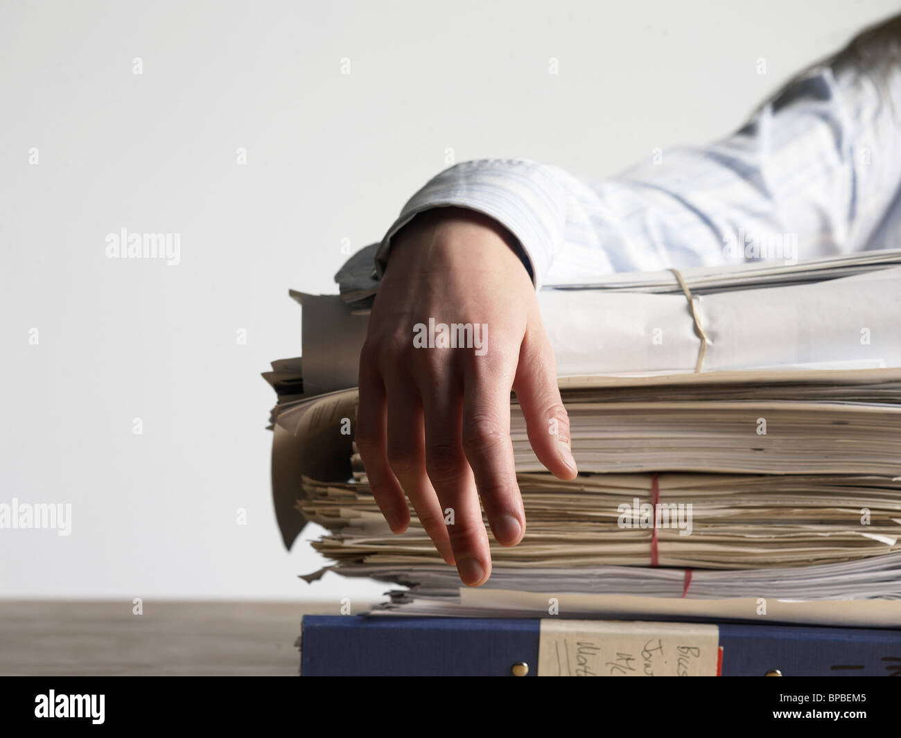 Arm resting on paper work Stock Photo - Alamy