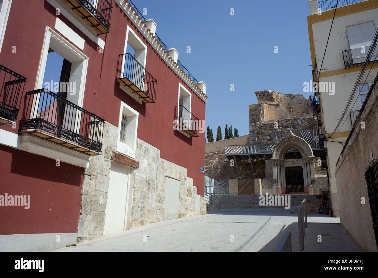 Photograph of a street in Cartagena, Spain, showing part of the ruins ...