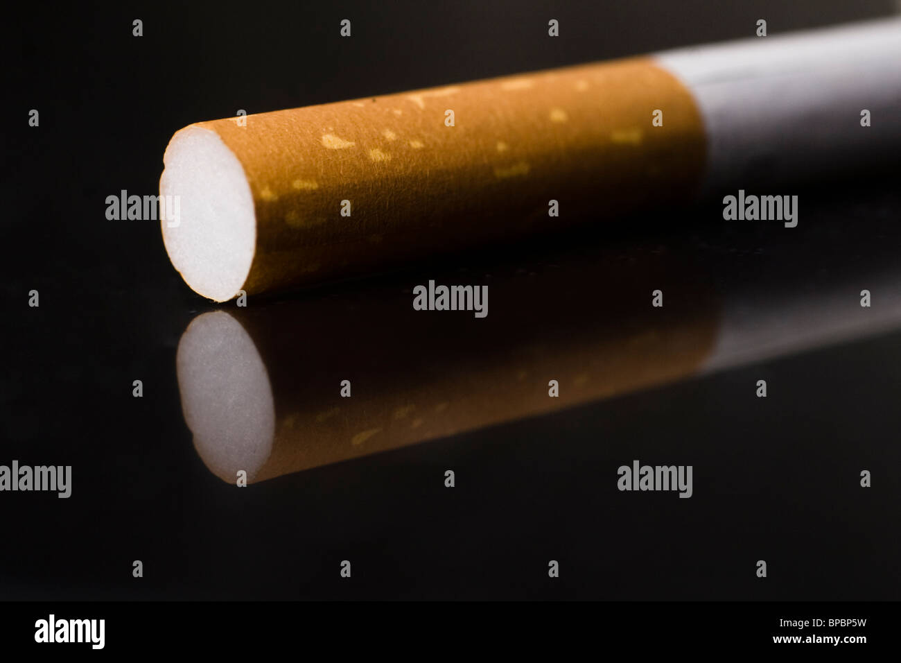 The end of a cigarette on a black background Stock Photo - Alamy