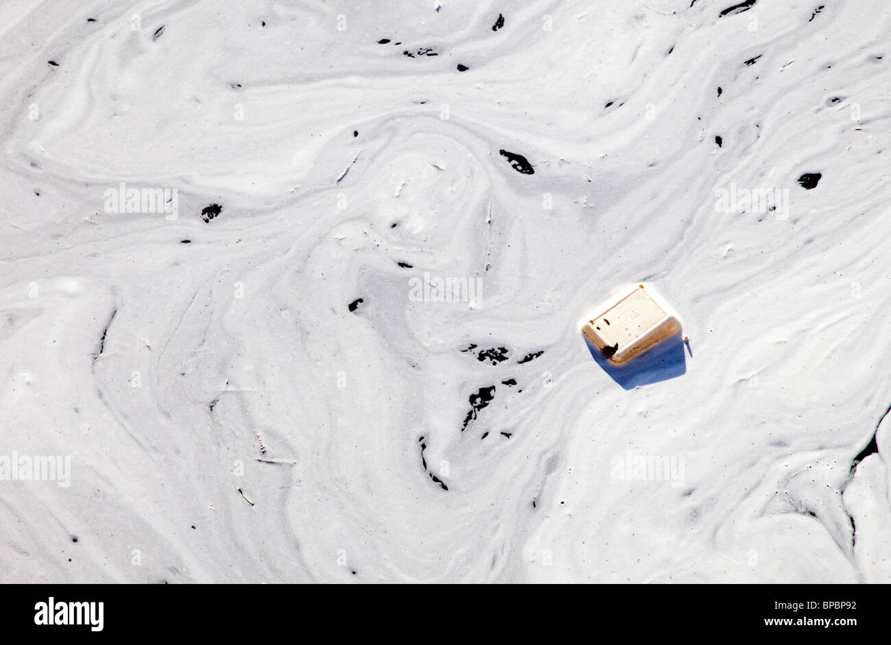 Layer of foam and waste floating on water surface Stock Photo - Alamy