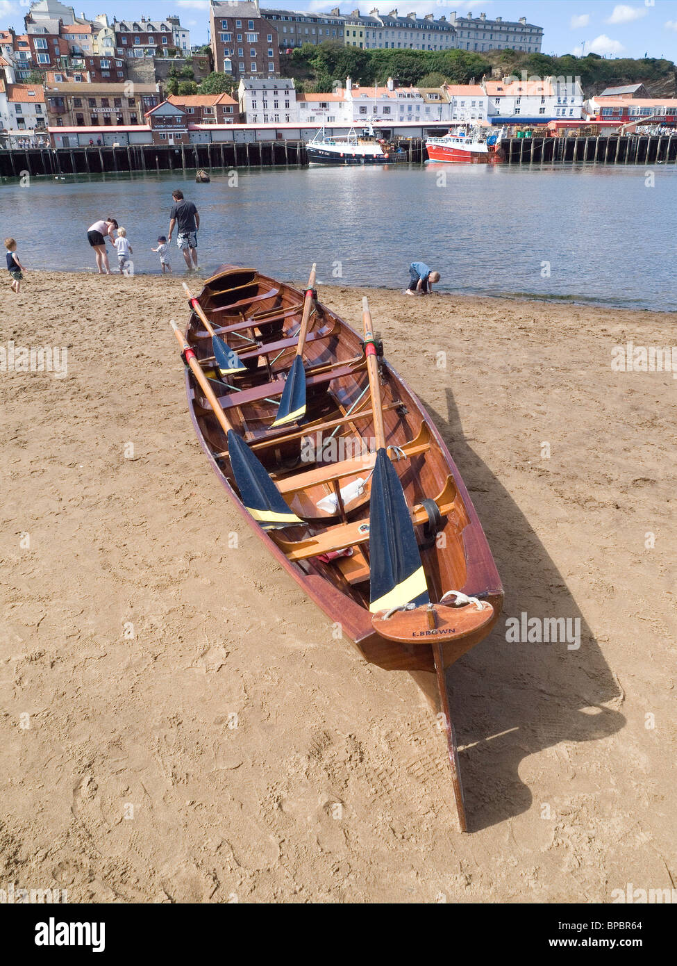 A traditional wooden sea going rowing boat on the beach at Whitby ...