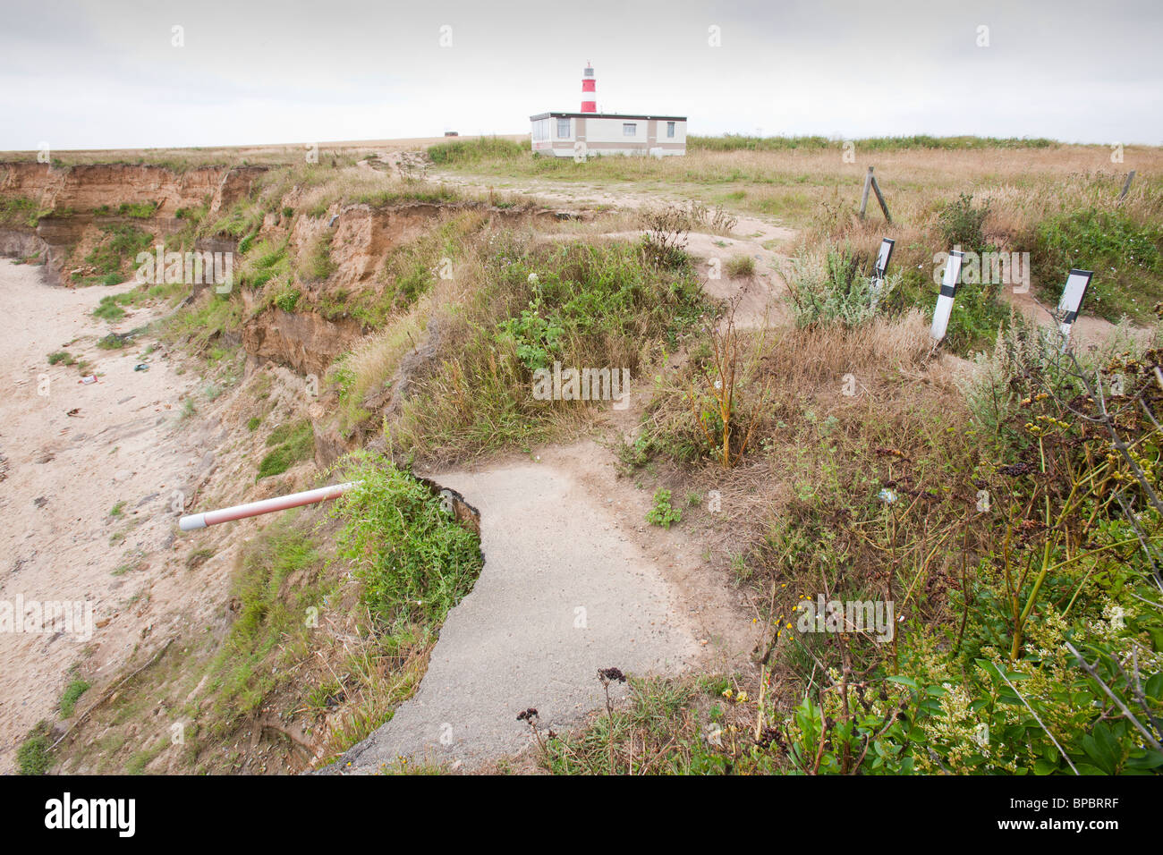 Remains of a road in Happisburgh, Norfolk that collapsed into the sea ...