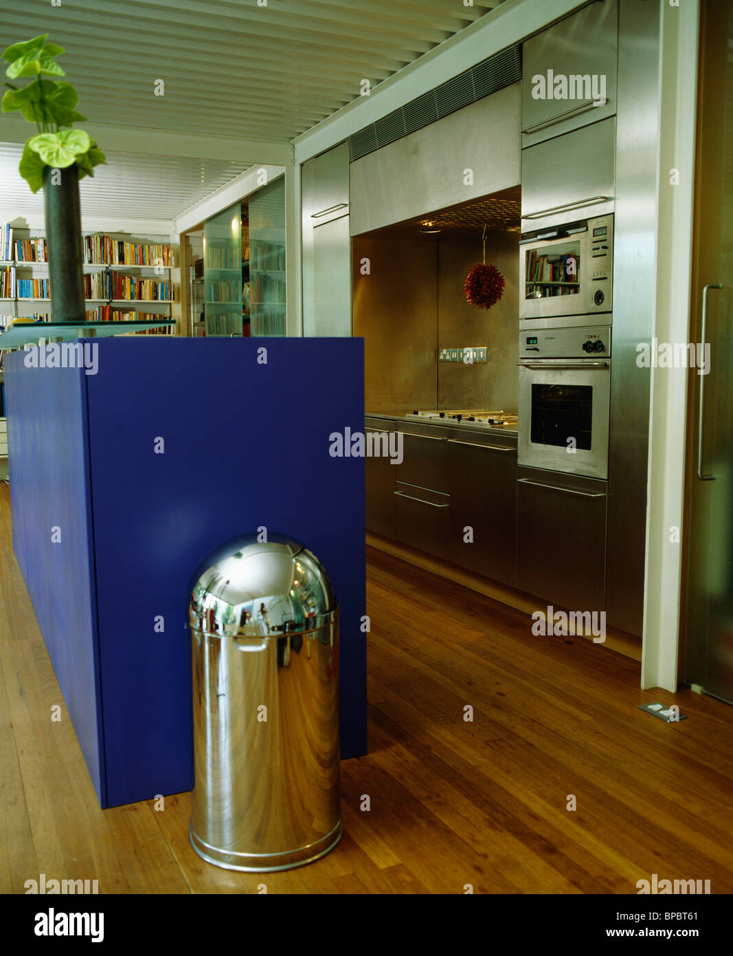 Stainless-steel cylindrical waste-bin in modern stainless steel kitchen ...