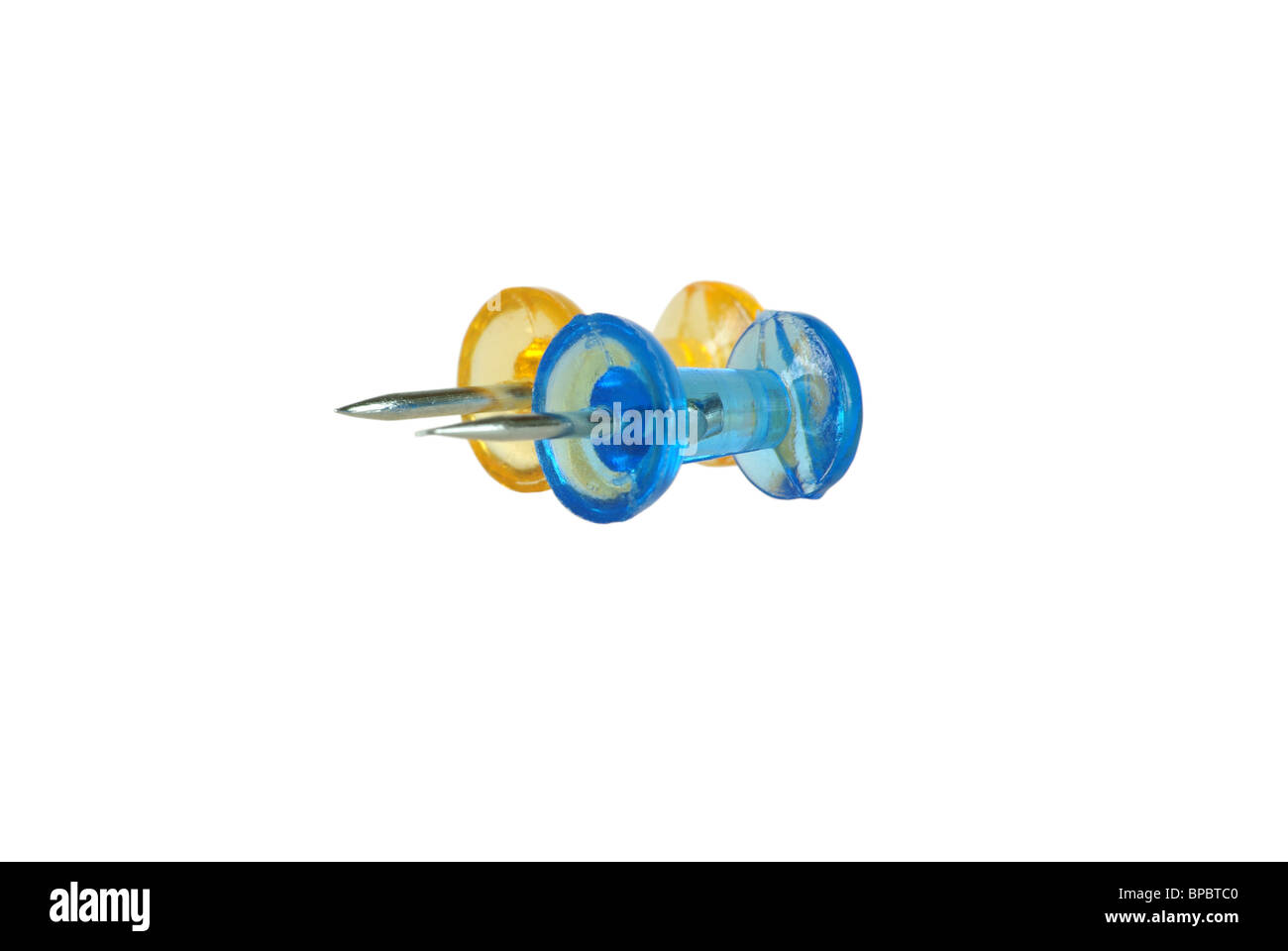 Orange and blue transparent drawing pins together. Isolated on white ...