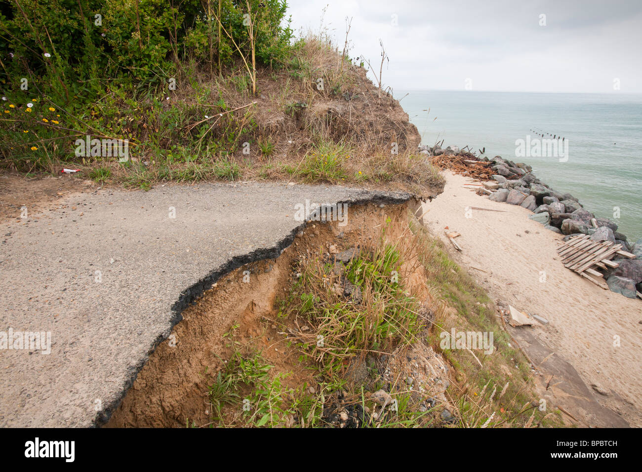 Remains of a road in Happisburgh, Norfolk that collapsed into the sea ...