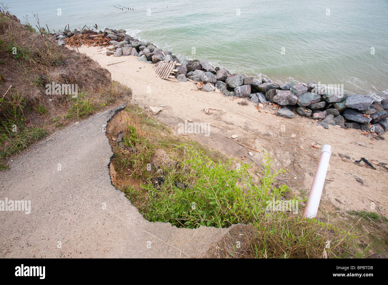 Remains of a road in Happisburgh, Norfolk that collapsed into the sea ...