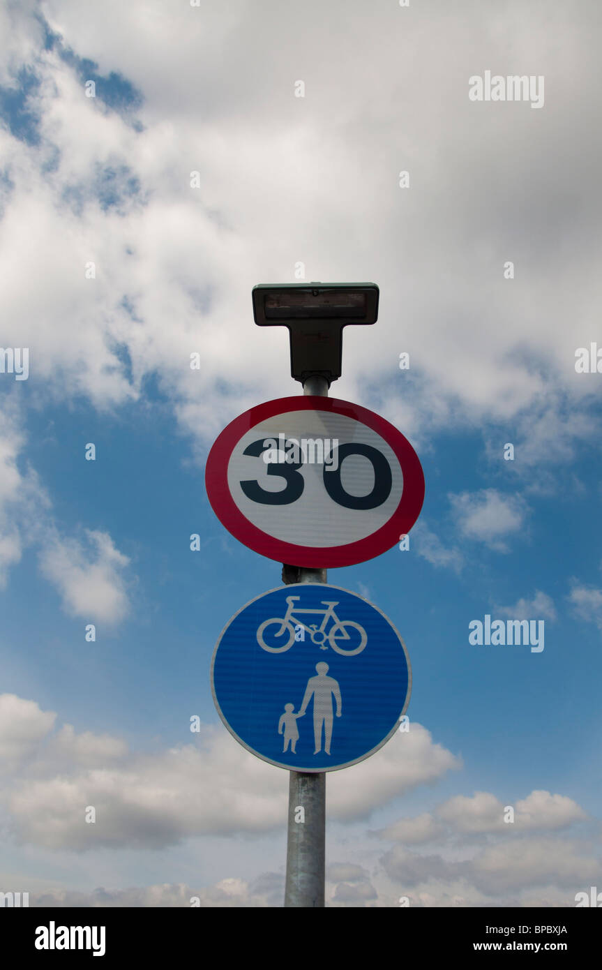 A 30mph roadsign and a cycleway and public footpath sign isolated ...