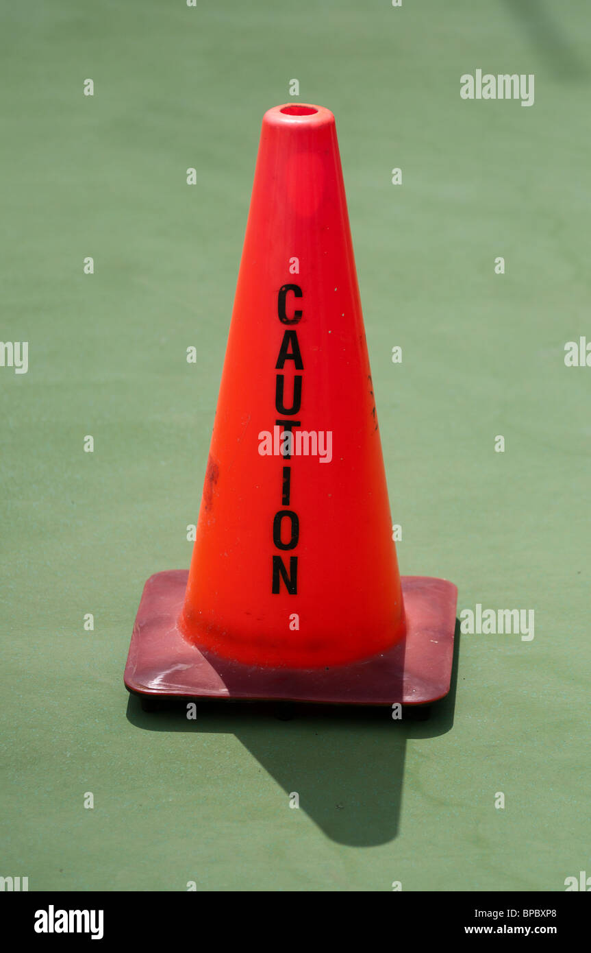A bright orange cone displaying the word 'CAUTION' Stock Photo - Alamy