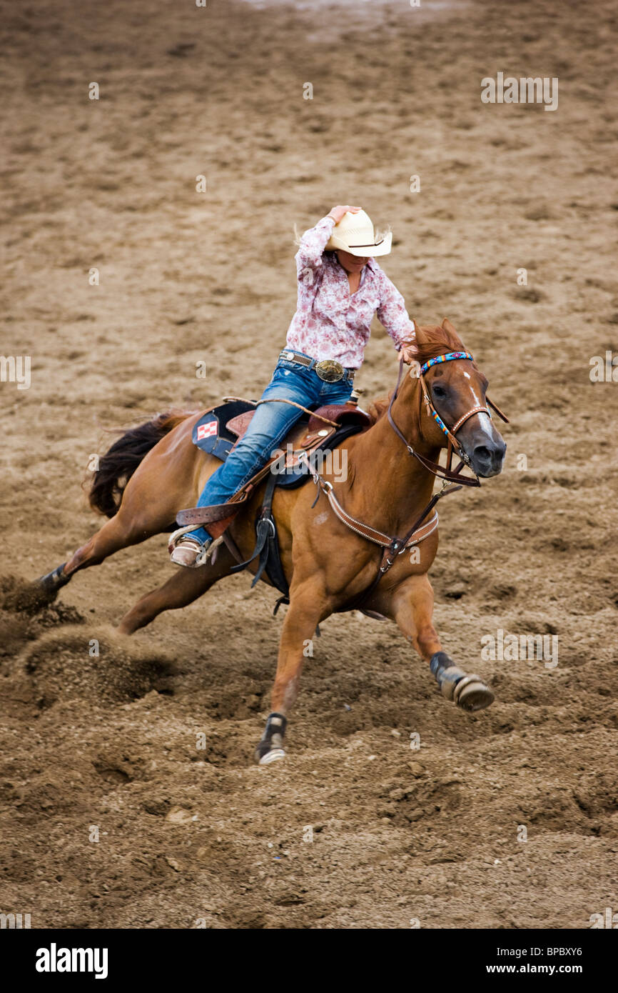 Cowgirl on horseback riding in the ladies barrel racing event, Chaffee ...