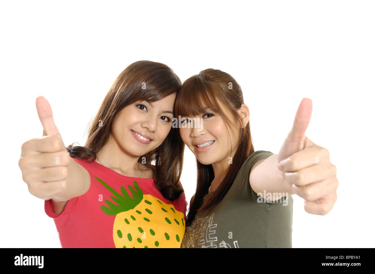 Female university students showing thumbs up sign Stock Photo - Alamy