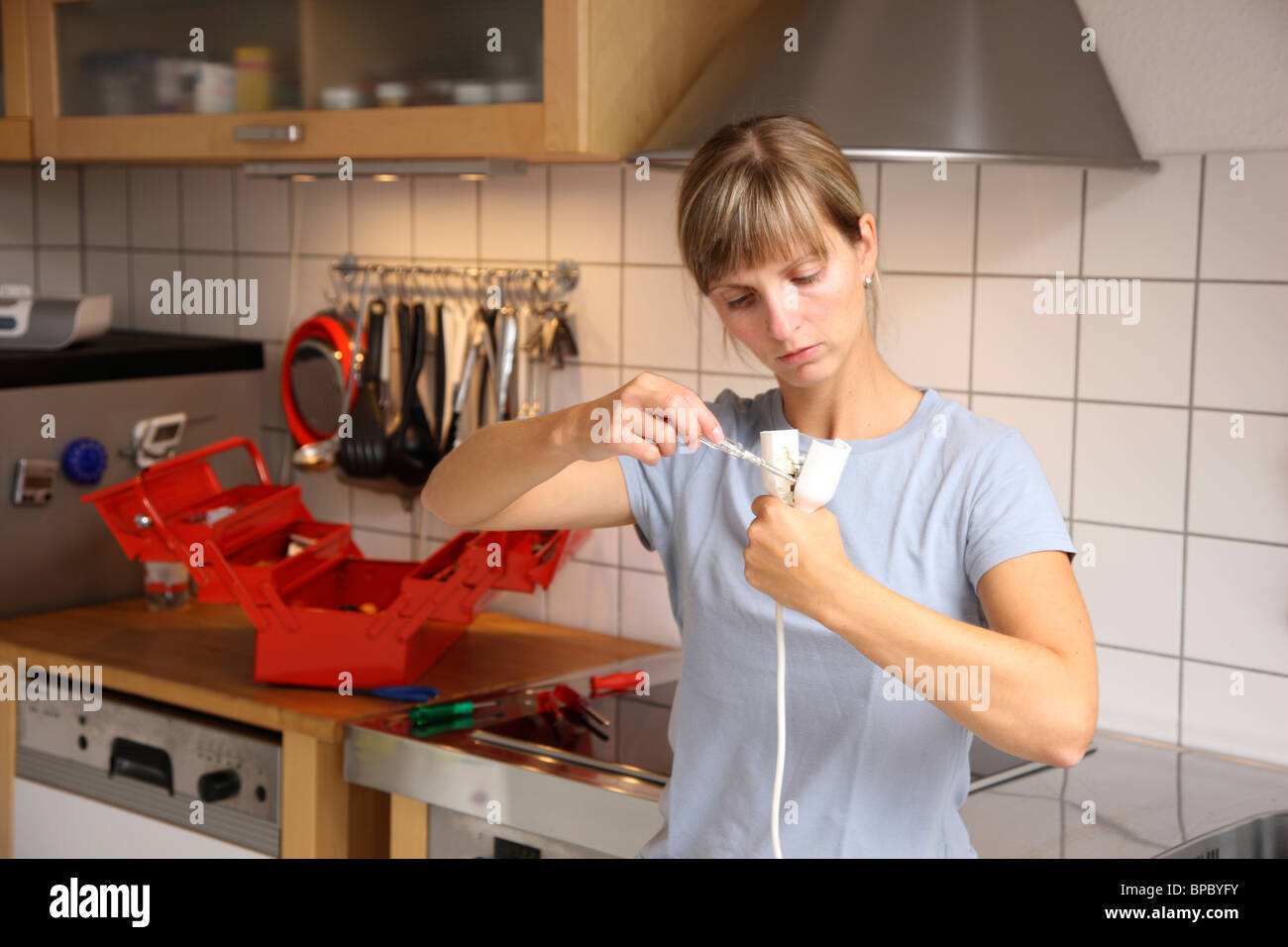 Young woman is working at home. Do it yourself work in her apartment ...