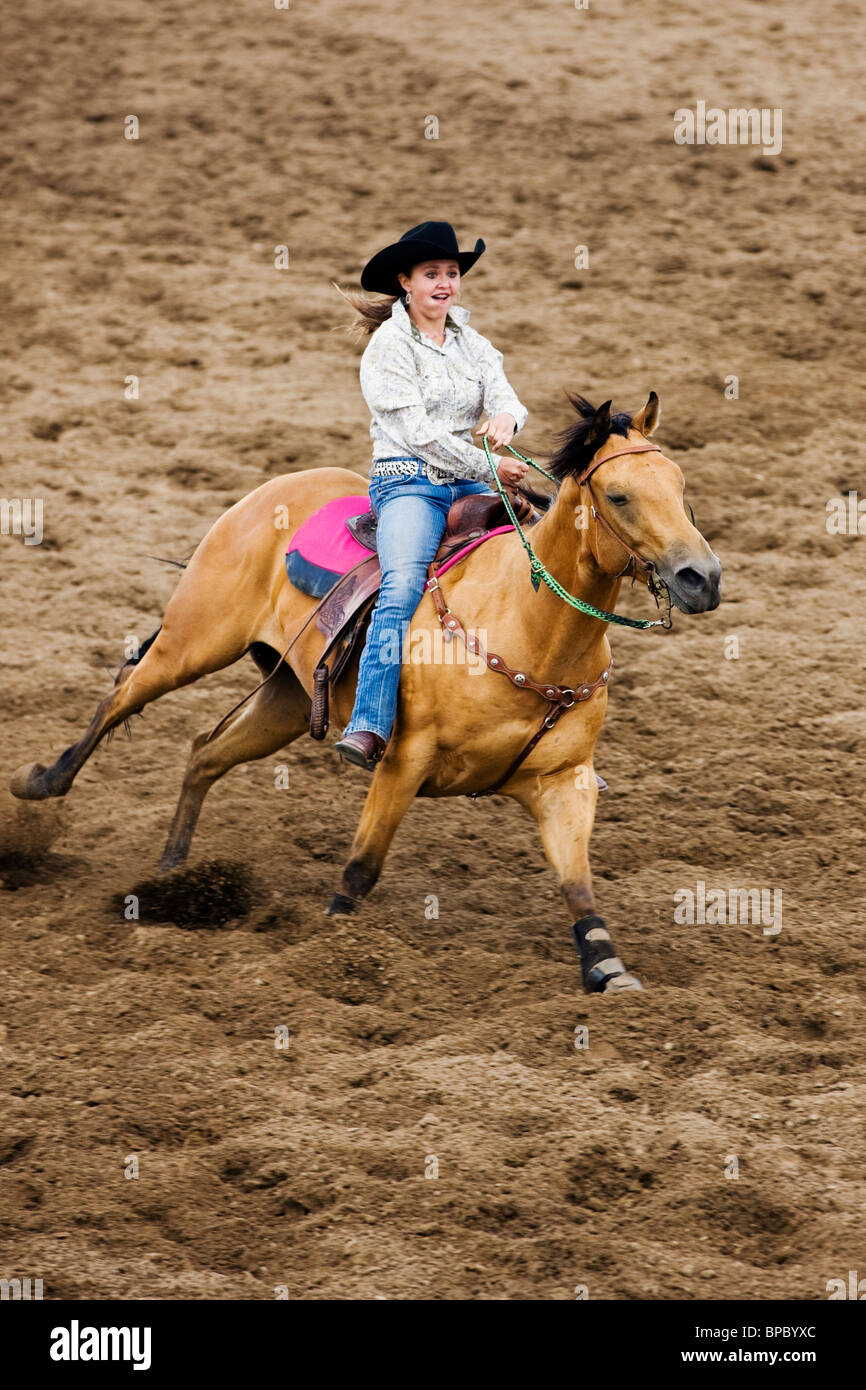 Cowgirl on horseback riding in the ladies barrel racing event, Chaffee ...