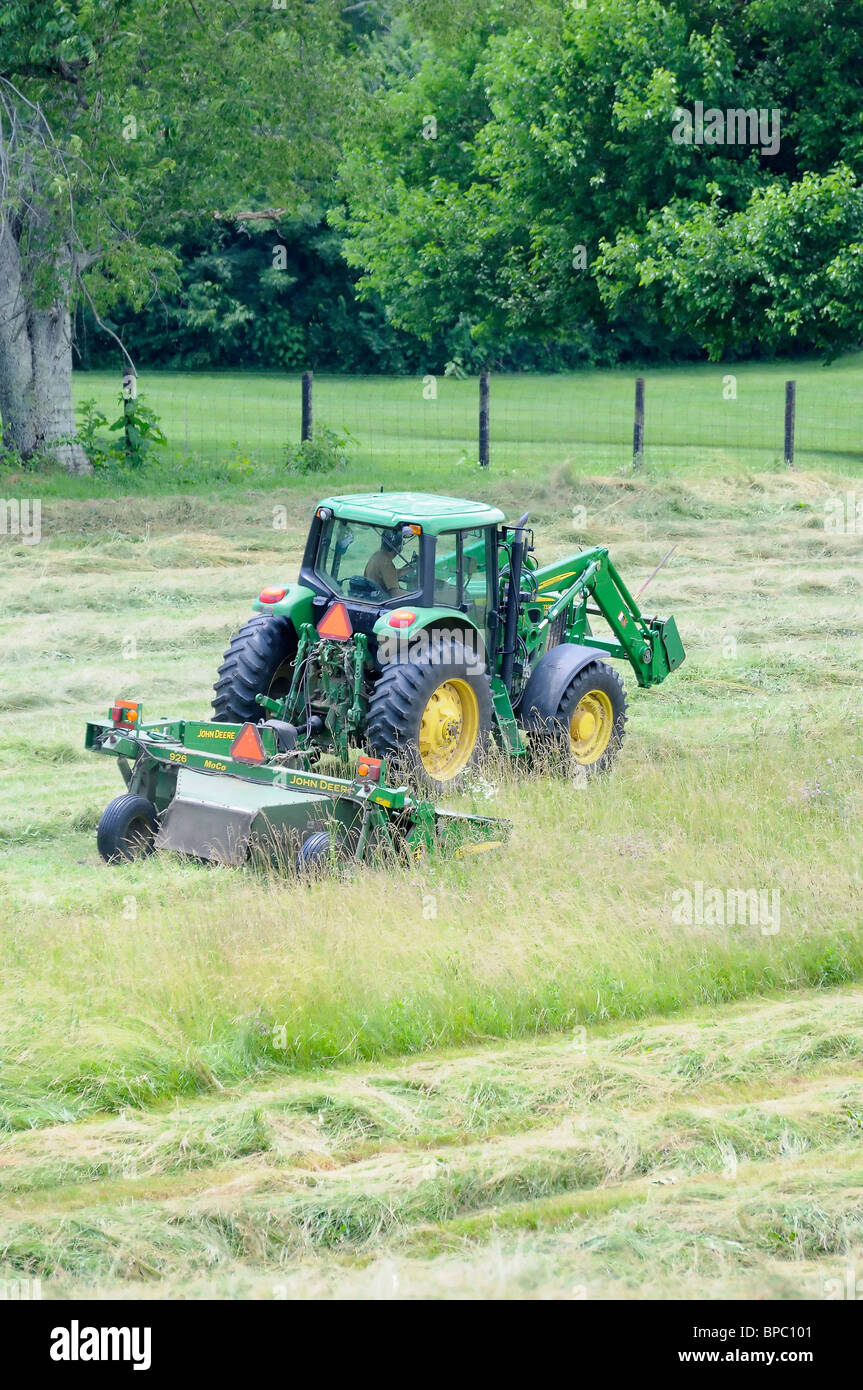 Tractor cutting hay in a field in Kentucky, USA Stock Photo - Alamy
