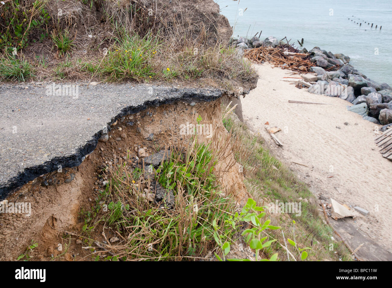 Remains of a road in Happisburgh, Norfolk that collapsed into the sea ...