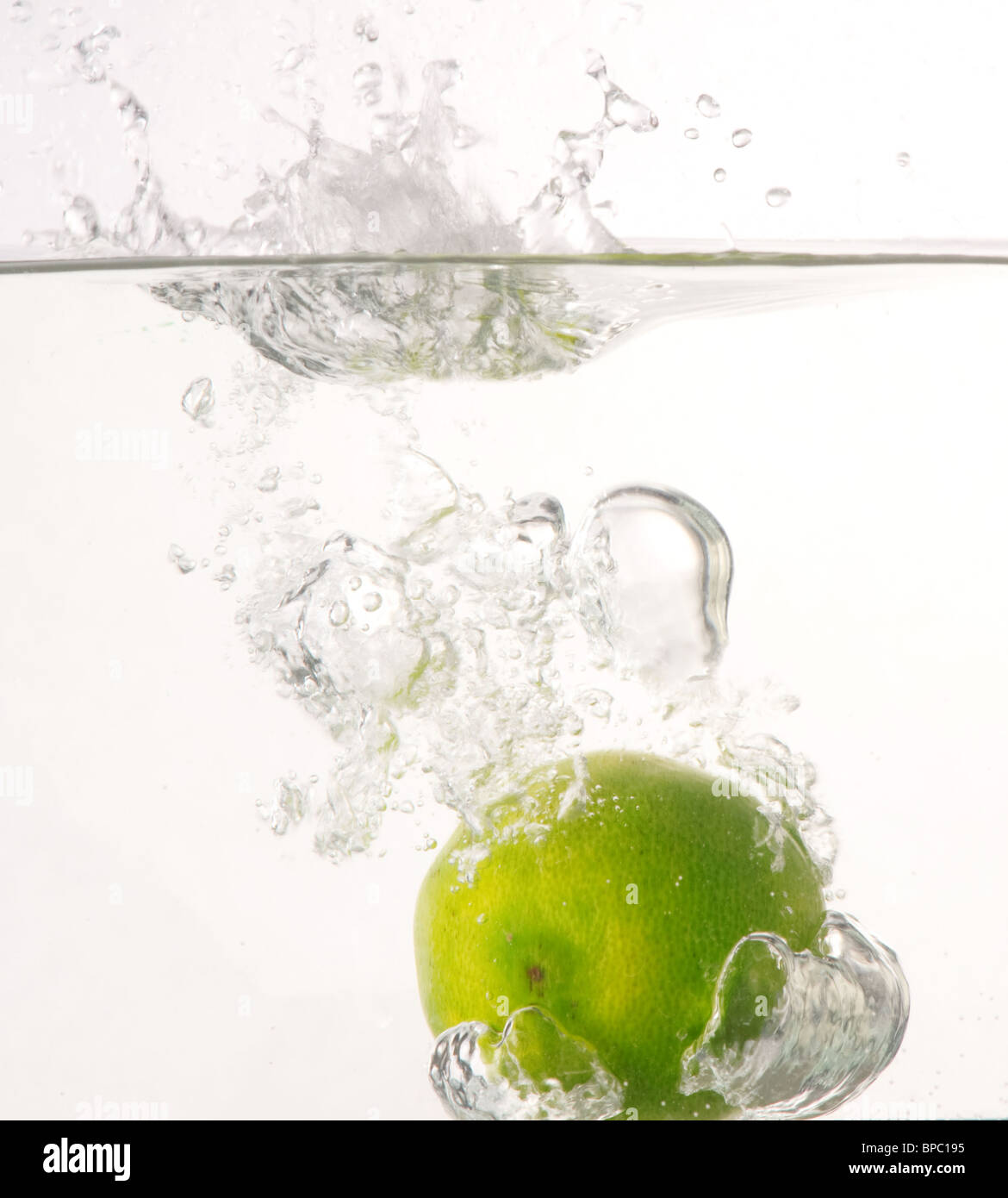 Lime whole, slices or pieces splash into cool clear water Stock Photo ...