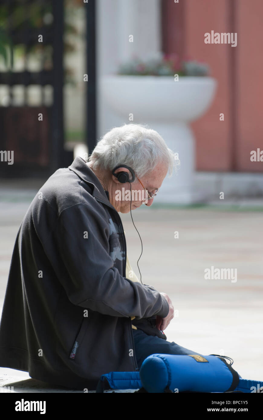 Sitting elderly man Stock Photo - Alamy