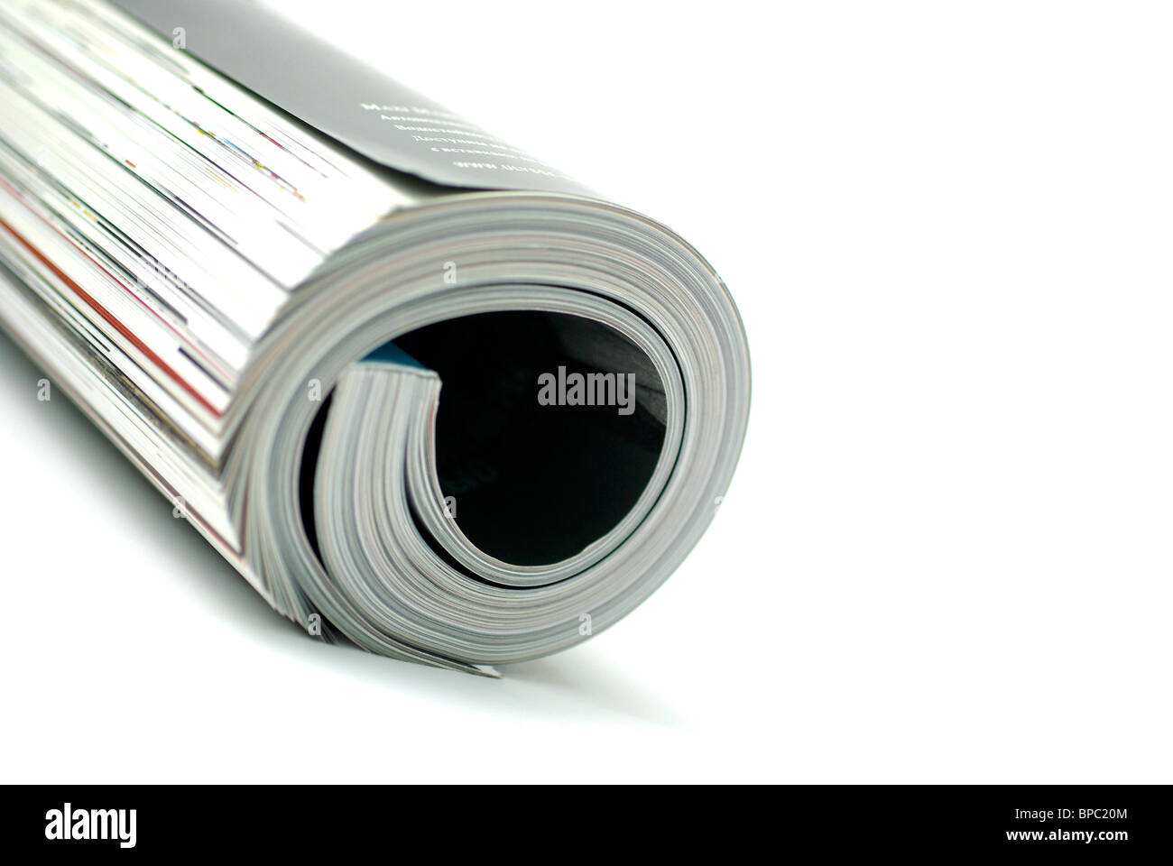 Rolled magazine isolated on white background Stock Photo - Alamy