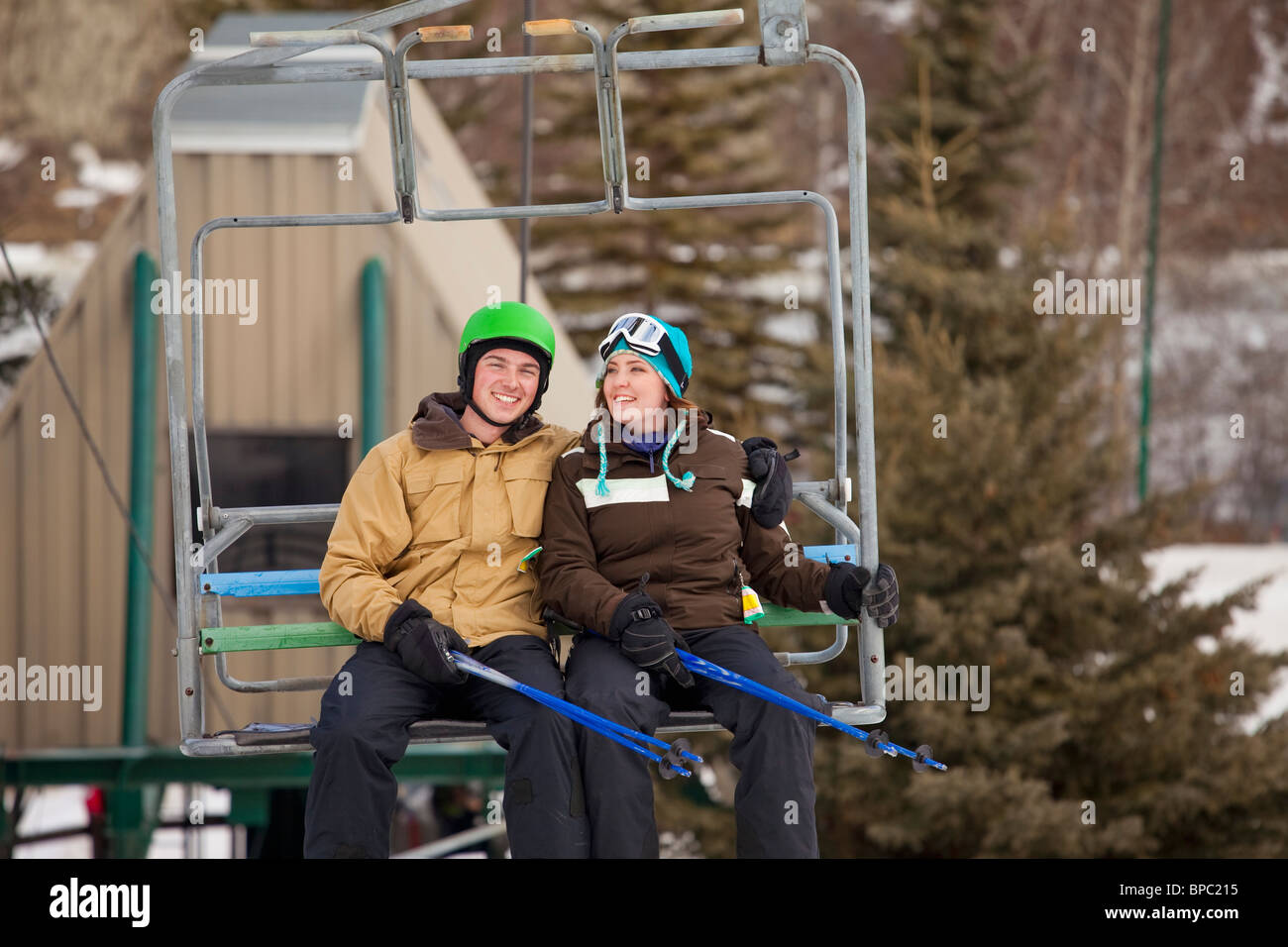 red deer, alberta, canada; a man and woman riding a chair lift at a ski ...