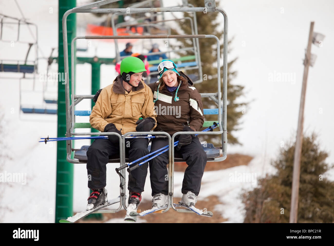 red deer, alberta, canada; a man and woman riding a chair lift at a ski ...