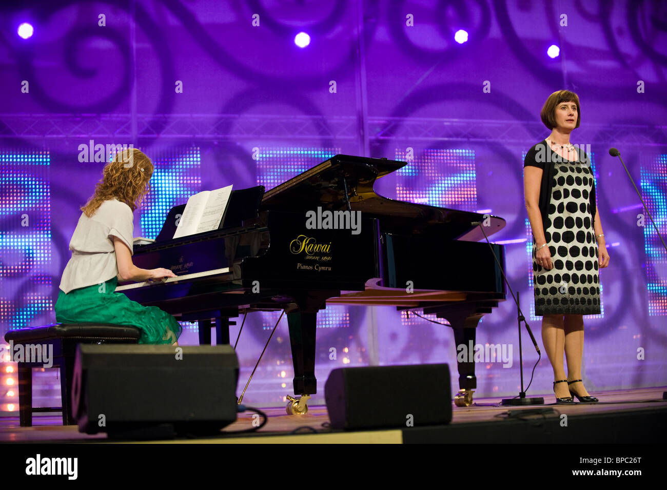 Female singer singing solo on stage in competition at the National ...
