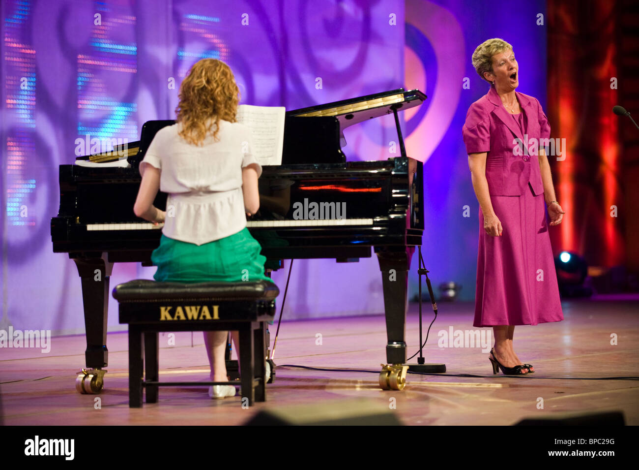 Female singer singing solo on stage in competition at the National ...