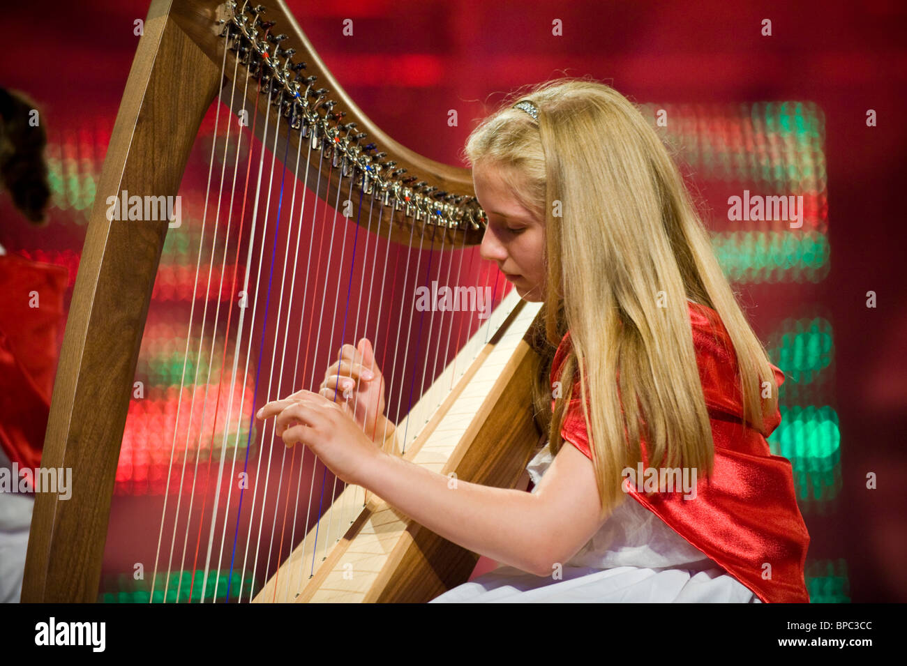Young woman harpist playing on stage in competition at the National ...