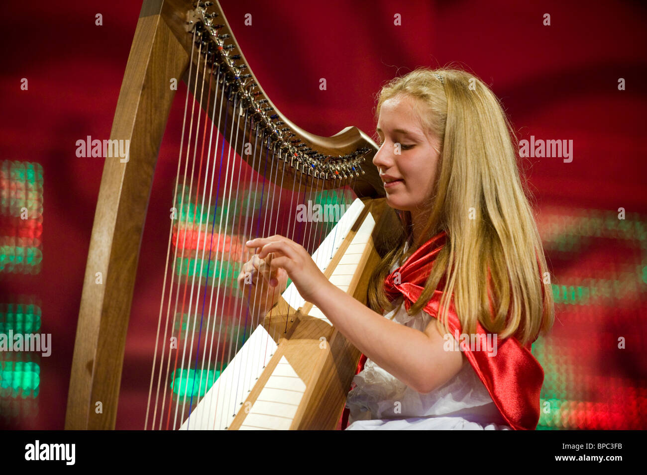 Young woman harpist playing on stage in competition at the National ...